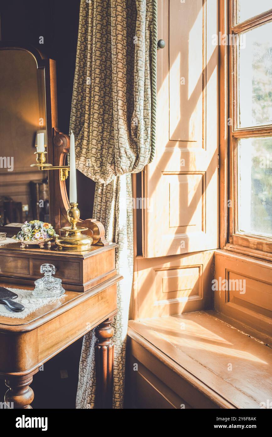 Sunlight pouring through a bedroom bay window in an English country ...