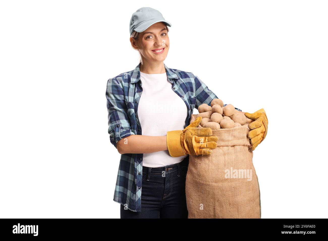 Young female farmer holding potatoes in a sack isolated on white ...