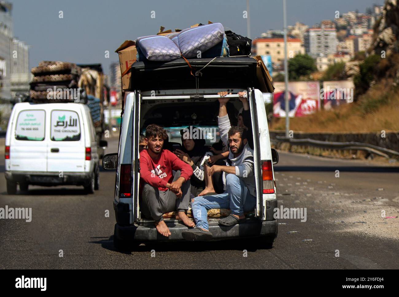 Sidon, Lebanon. 25th Sep, 2024. A Lebanese family sit inside a van as ...
