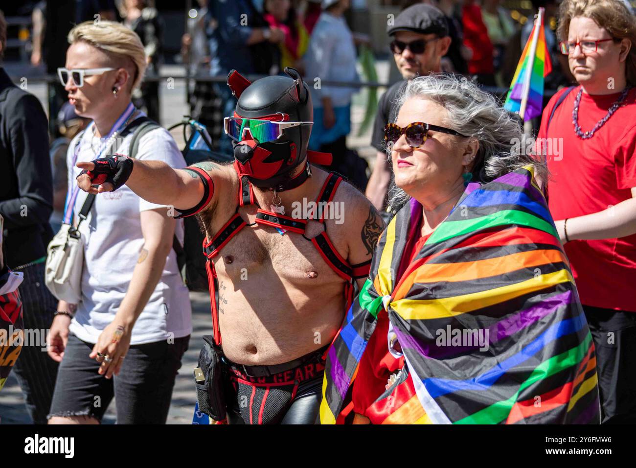 Couple at Helsinki Pride 2024 parade. Man wearing sunglasses, puppy ...