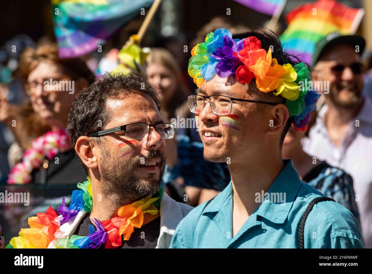 Male couple with colorful leis at Helsinki Pride 2024 Parade on ...