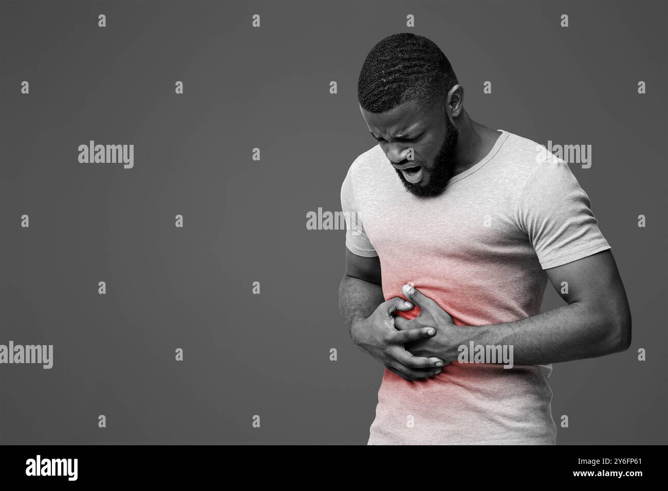 Young black guy suffering from stomach ulcer Stock Photo - Alamy