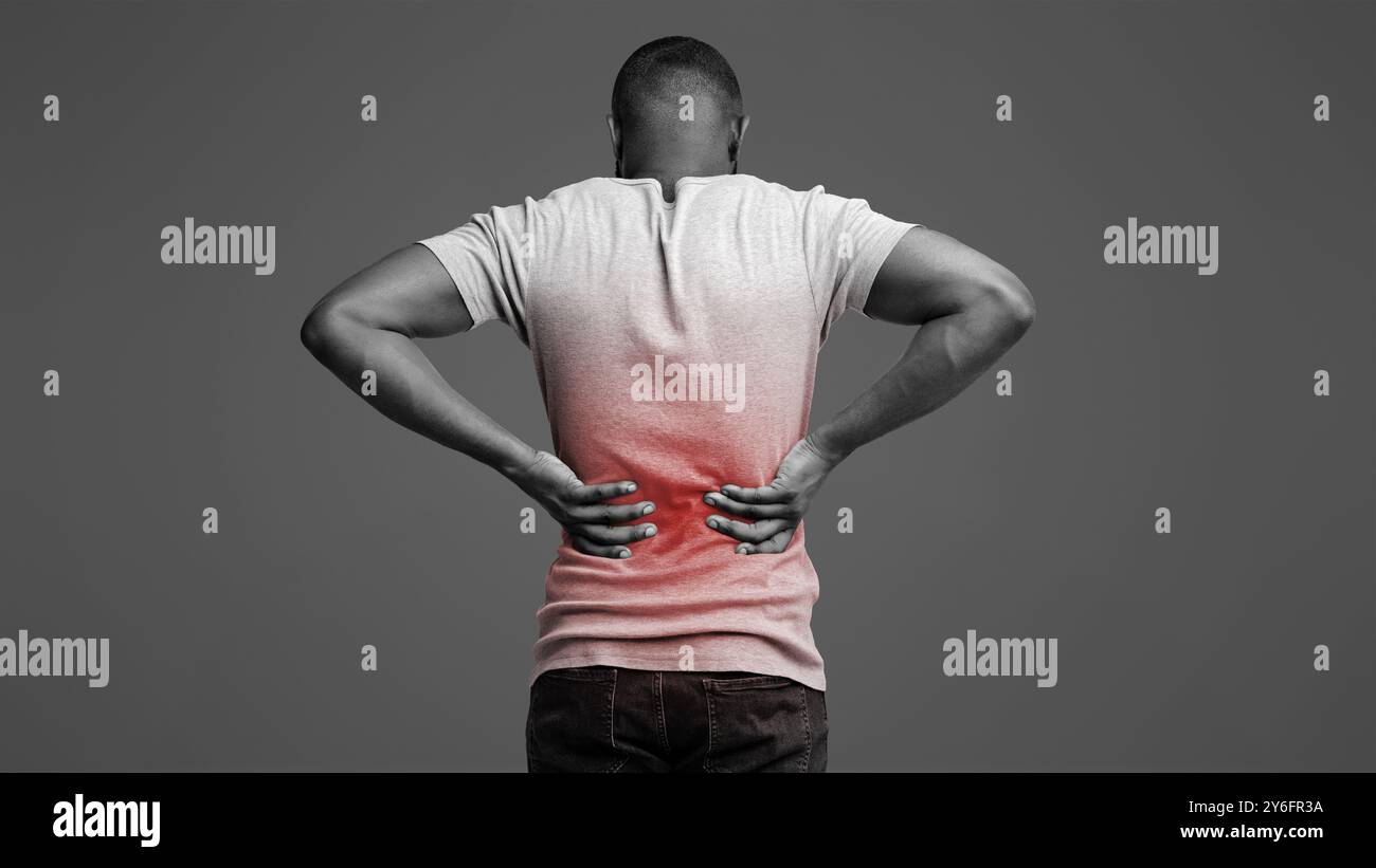 Black man holding his hands behind his back Stock Photo - Alamy