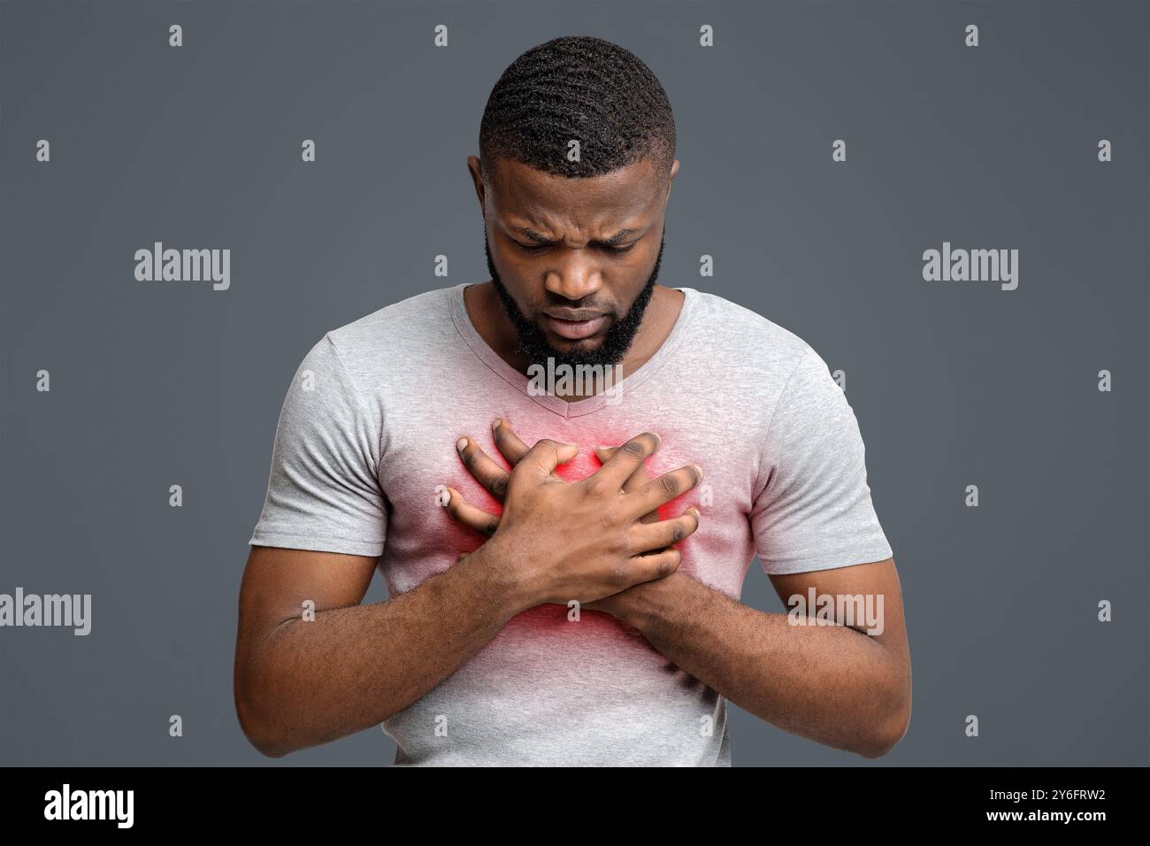Sad young man suffering from acute pain in chest Stock Photo - Alamy