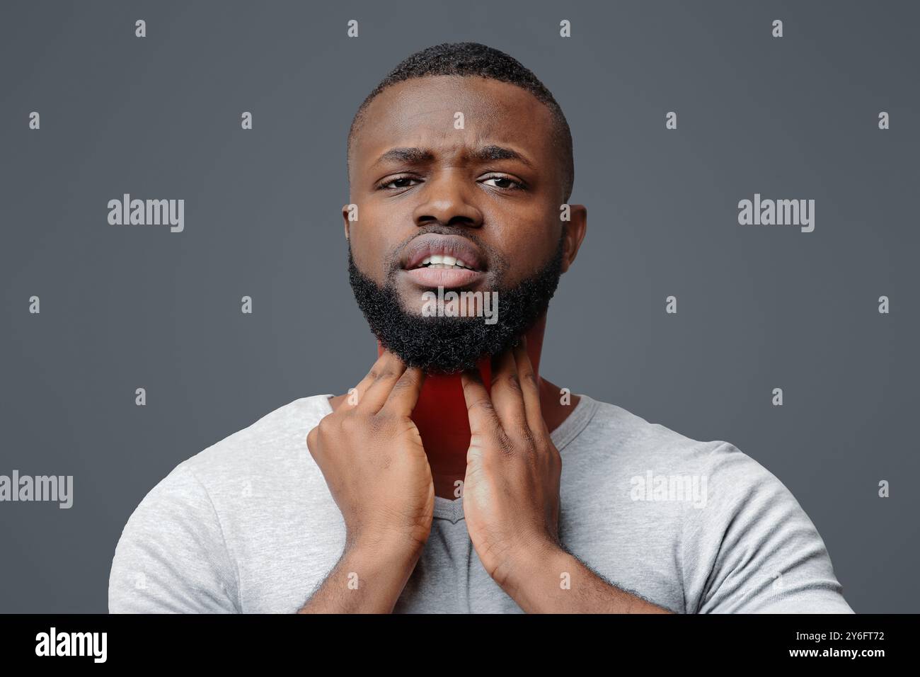 Young black guy suffering from chronic pharyngitis Stock Photo - Alamy