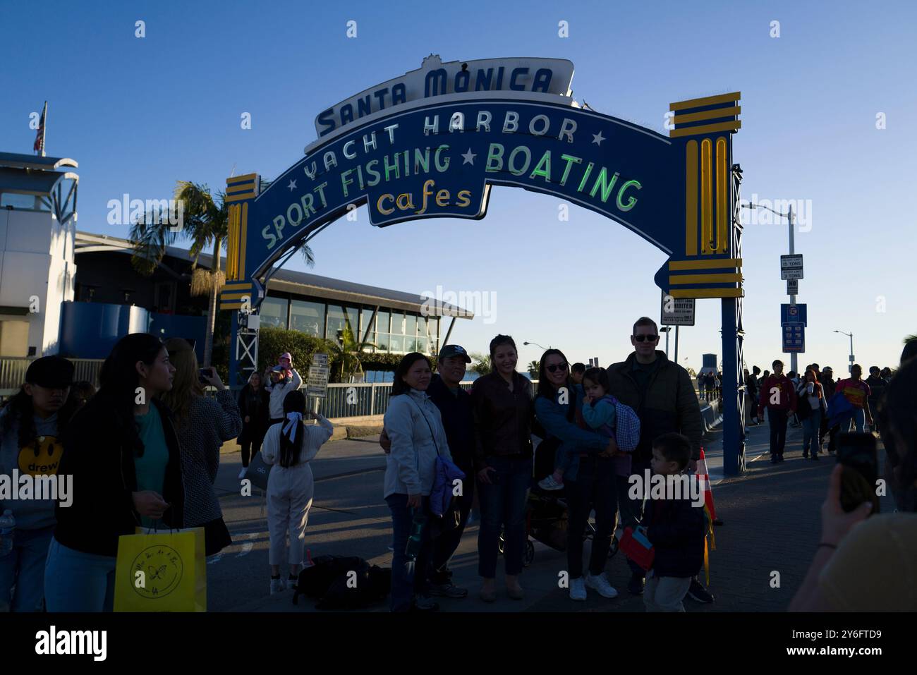 Crowds gather under the Santa Monica Yacht Harbor sign, enjoying a day ...