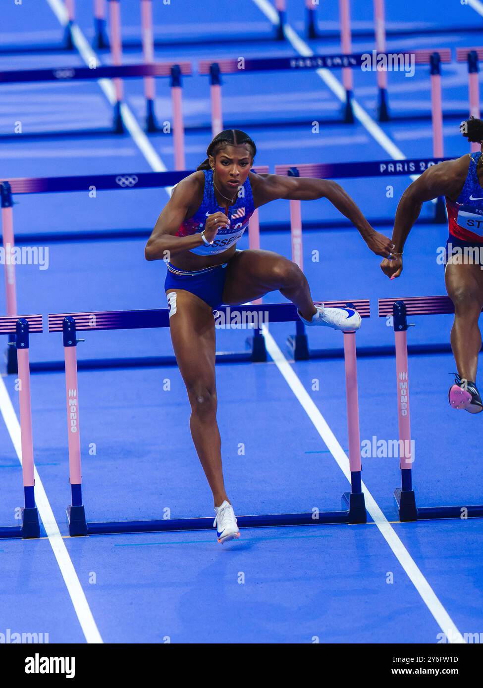 Masai Russell participating in the 100 meters hurdles at the Paris 2024 ...