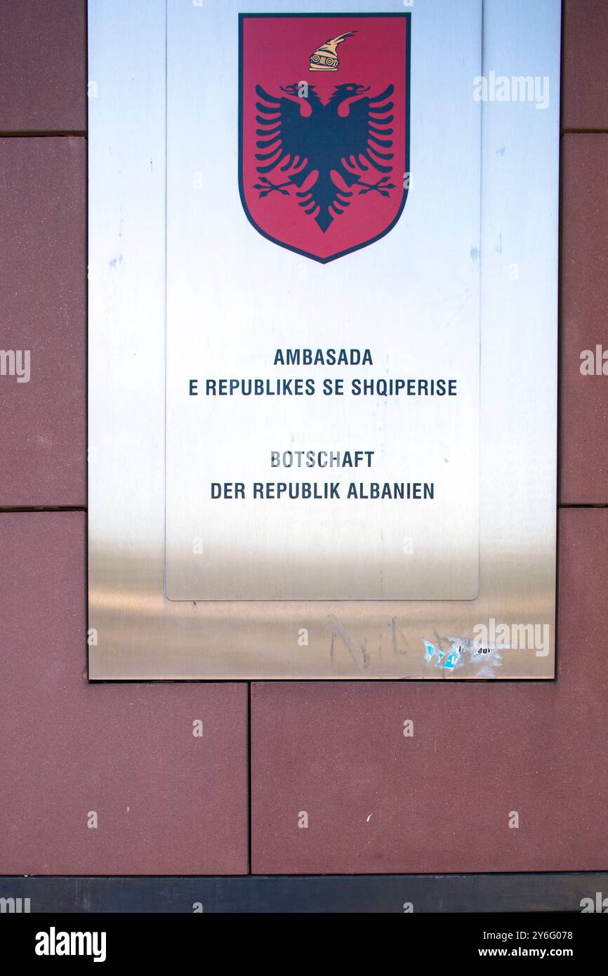 The sign of the Albanian embassy is prominently displayed on the wall ...