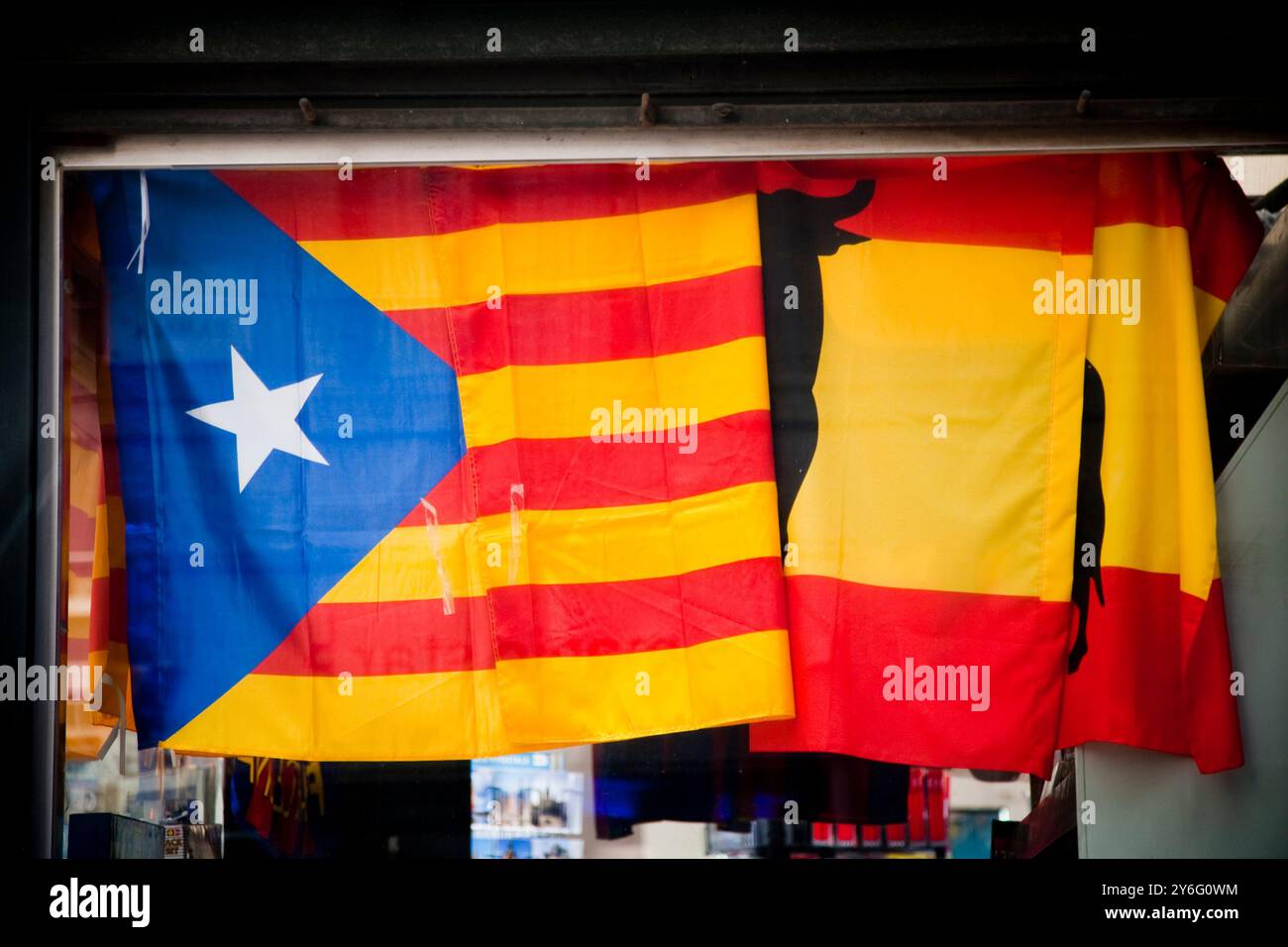 Catalan and Spanish flags hang side by side in a Las Ramblas shop ...