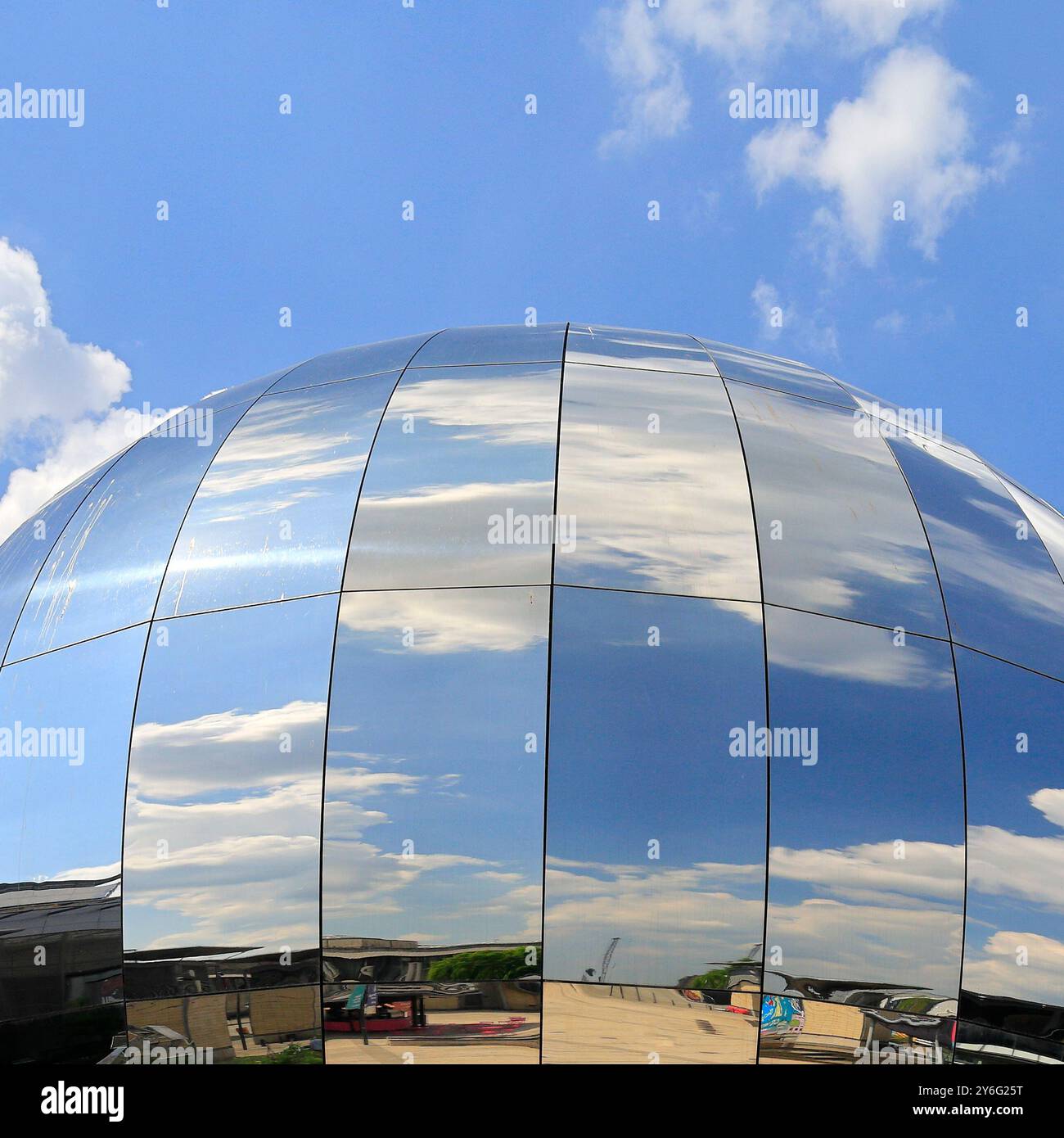 The Millennium Sphere reflecting blue sky and fluffy clouds in ...