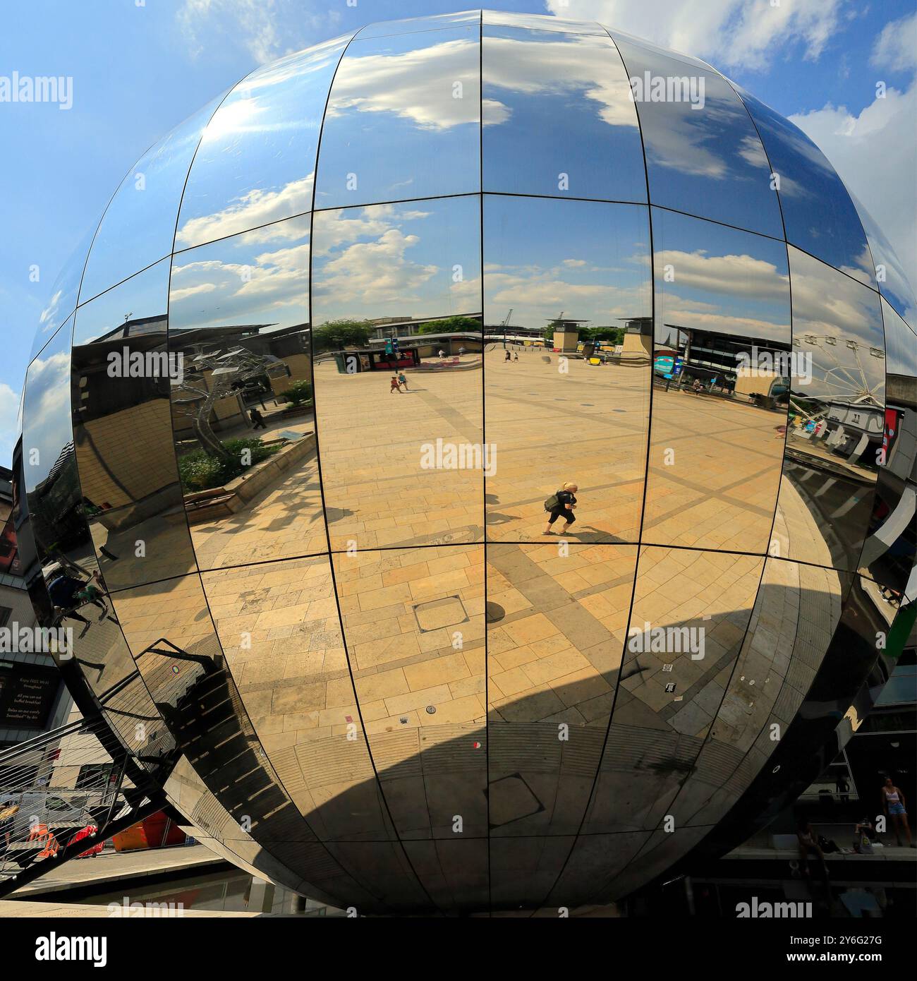 The Millennium Sphere reflecting blue sky and fluffy clouds in ...