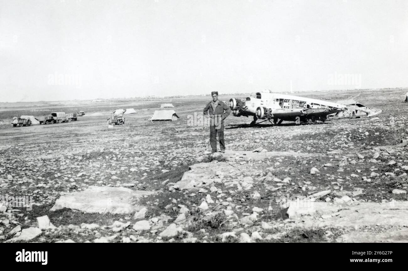 A Royal Air Force leading aircraftman next to a downed Junkers Ju 52 in ...
