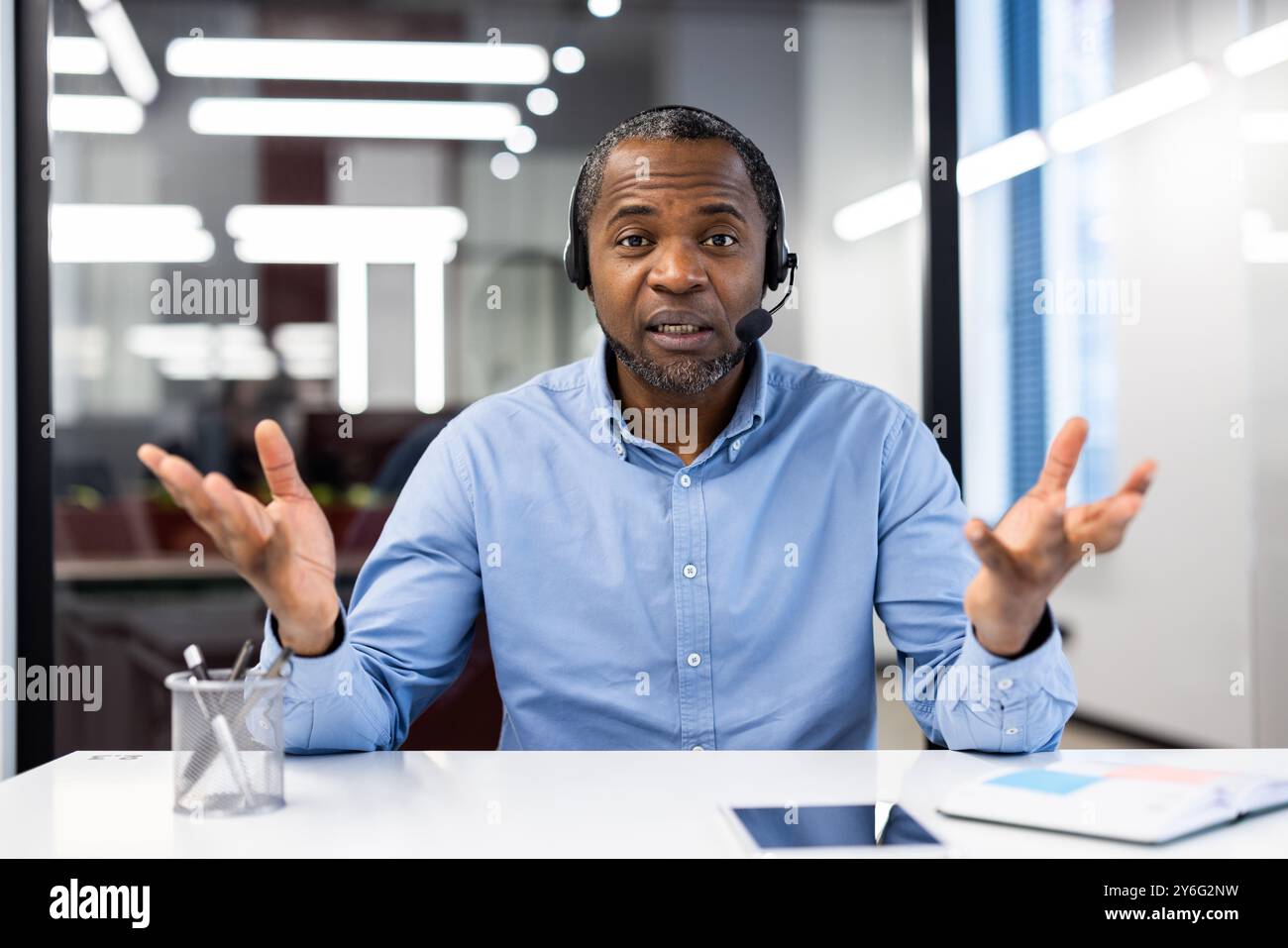Confident professional man wearing headset participates in video call ...