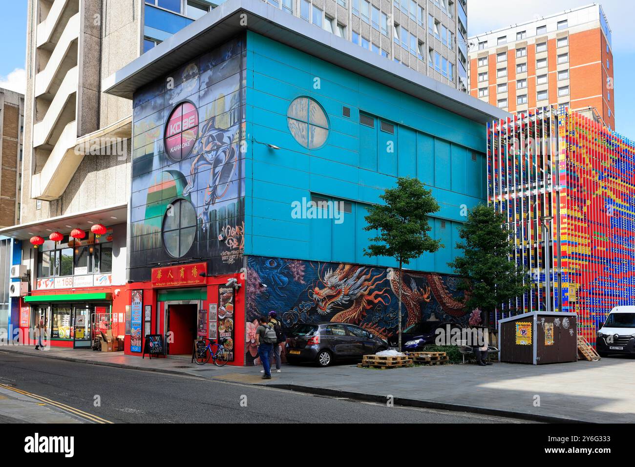 Brightly painted oriental style store front / shop with dragon mural ...