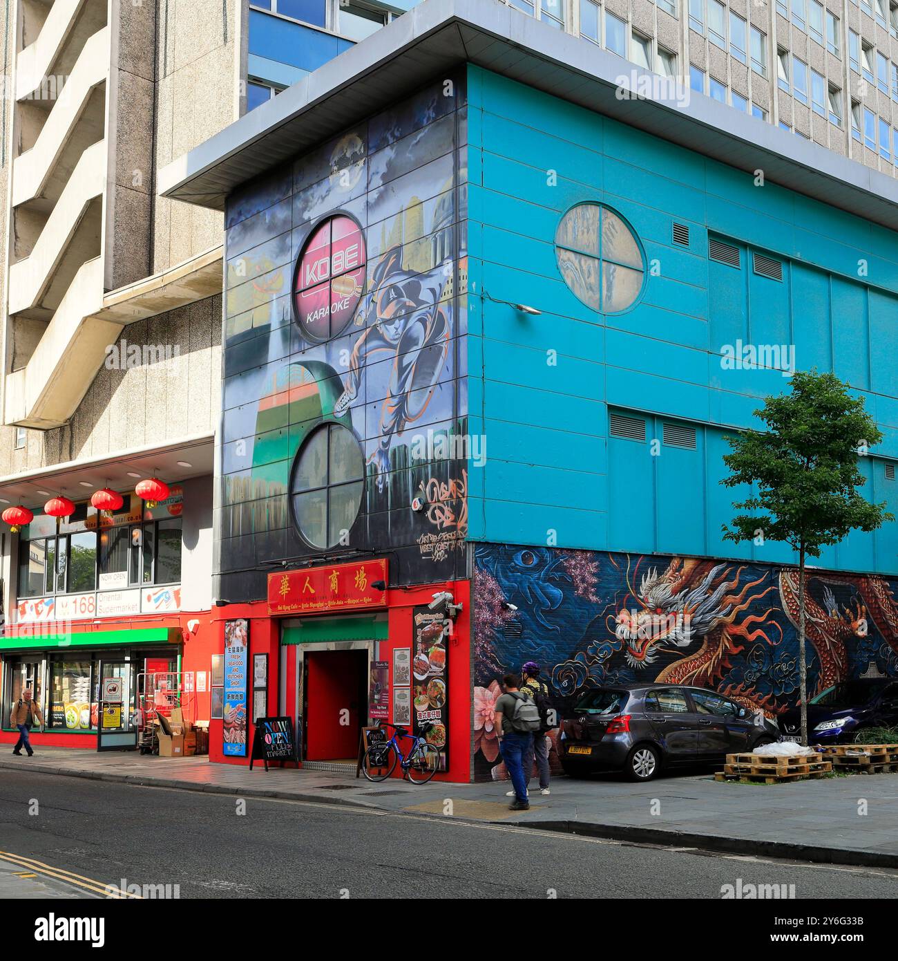 Brightly painted oriental style store front / shop with dragon mural ...