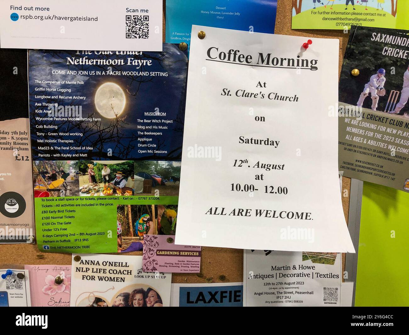 Notices pinned with drawing pins on a noticeboard in a small town ...