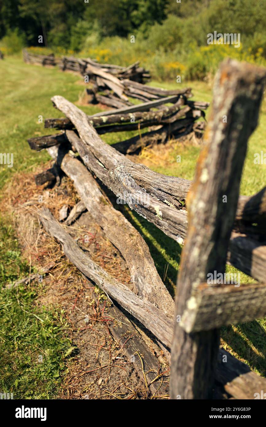A Close up on an old falling apart, split rail wood fence in a zigzag ...