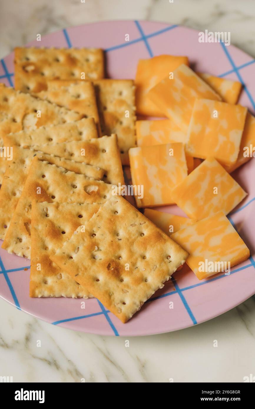 square pieces of colby jack cheese with rosemary saltine crackers Stock ...
