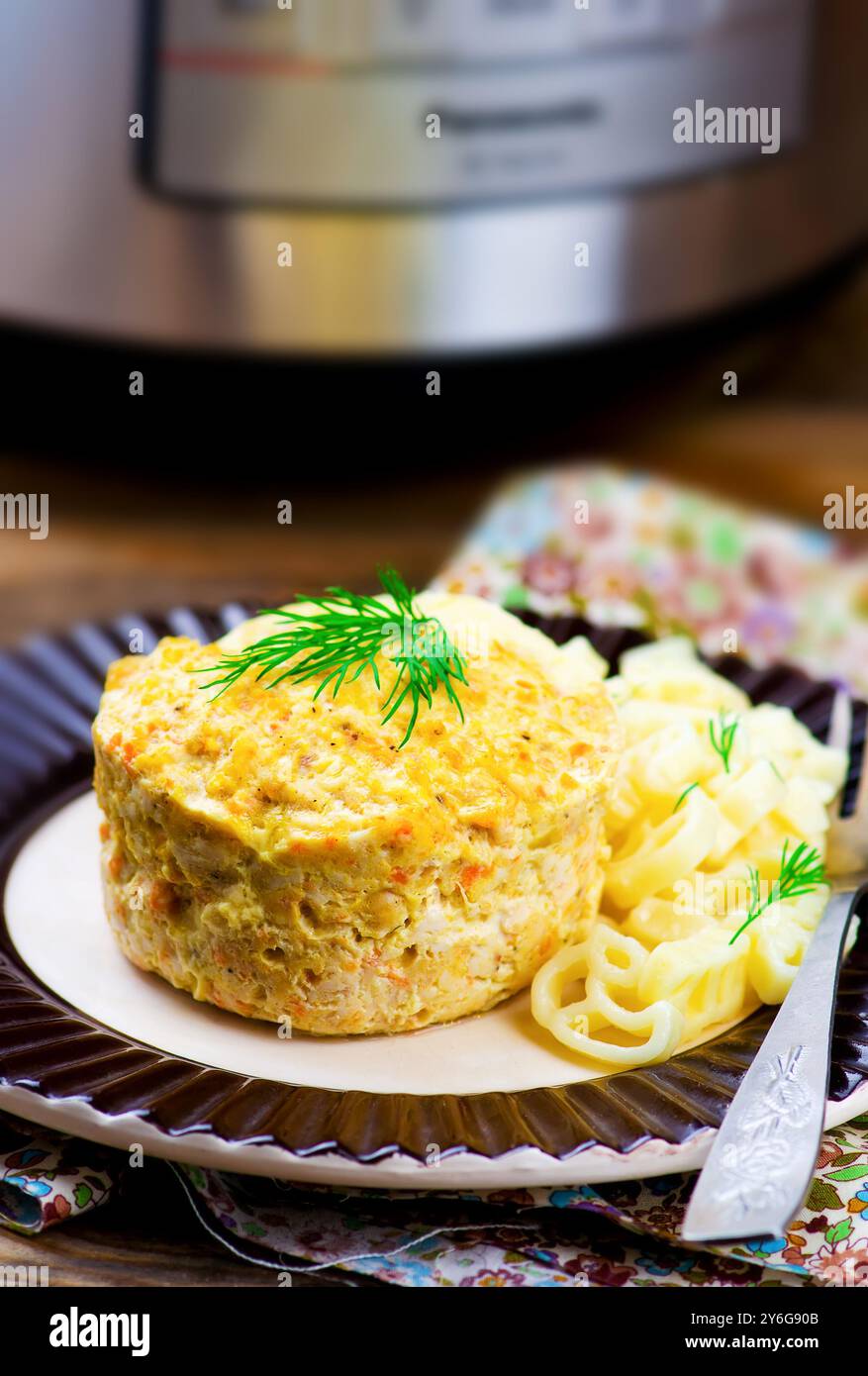 chicken souffle prepared in the crock-pot and macaroni on a plate Stock ...