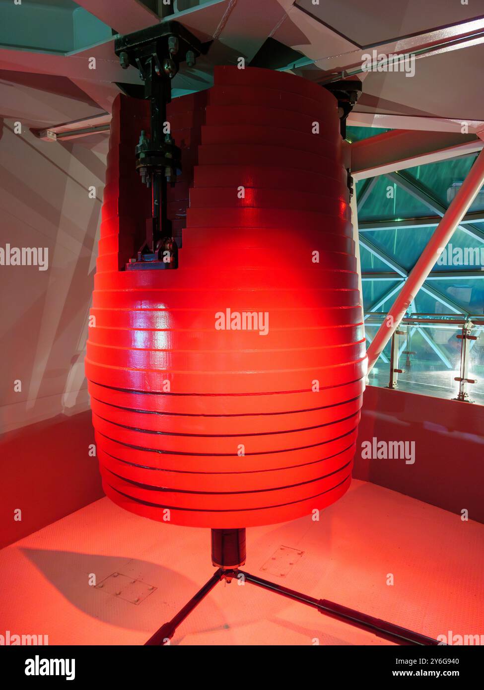 Red tuned mass damper pendulum is installed on the top floor of a high ...
