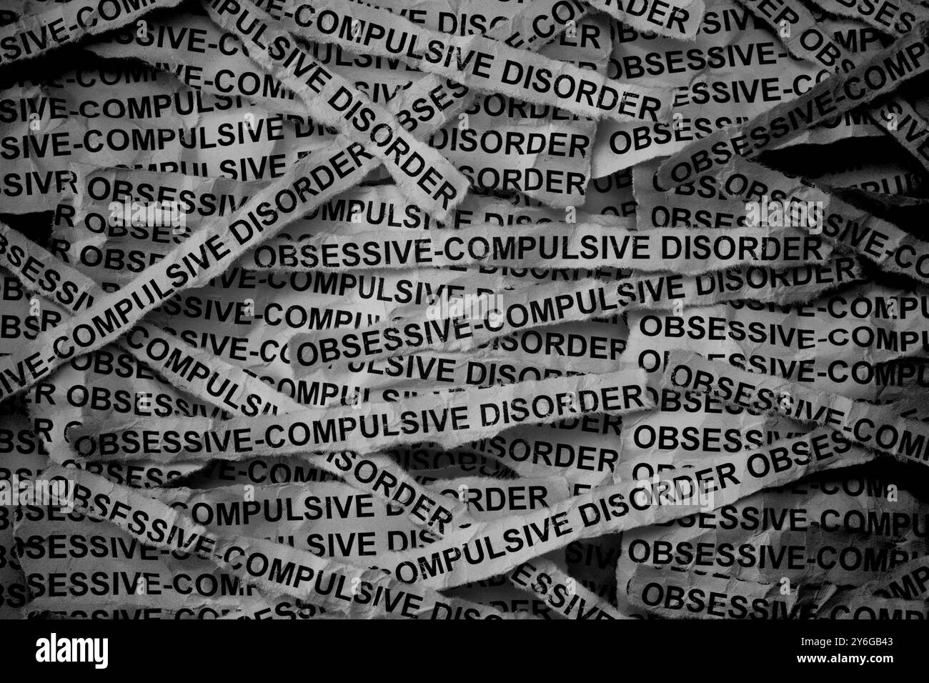 Strips of newspaper with the words Obsessive compulsive disorder typed ...