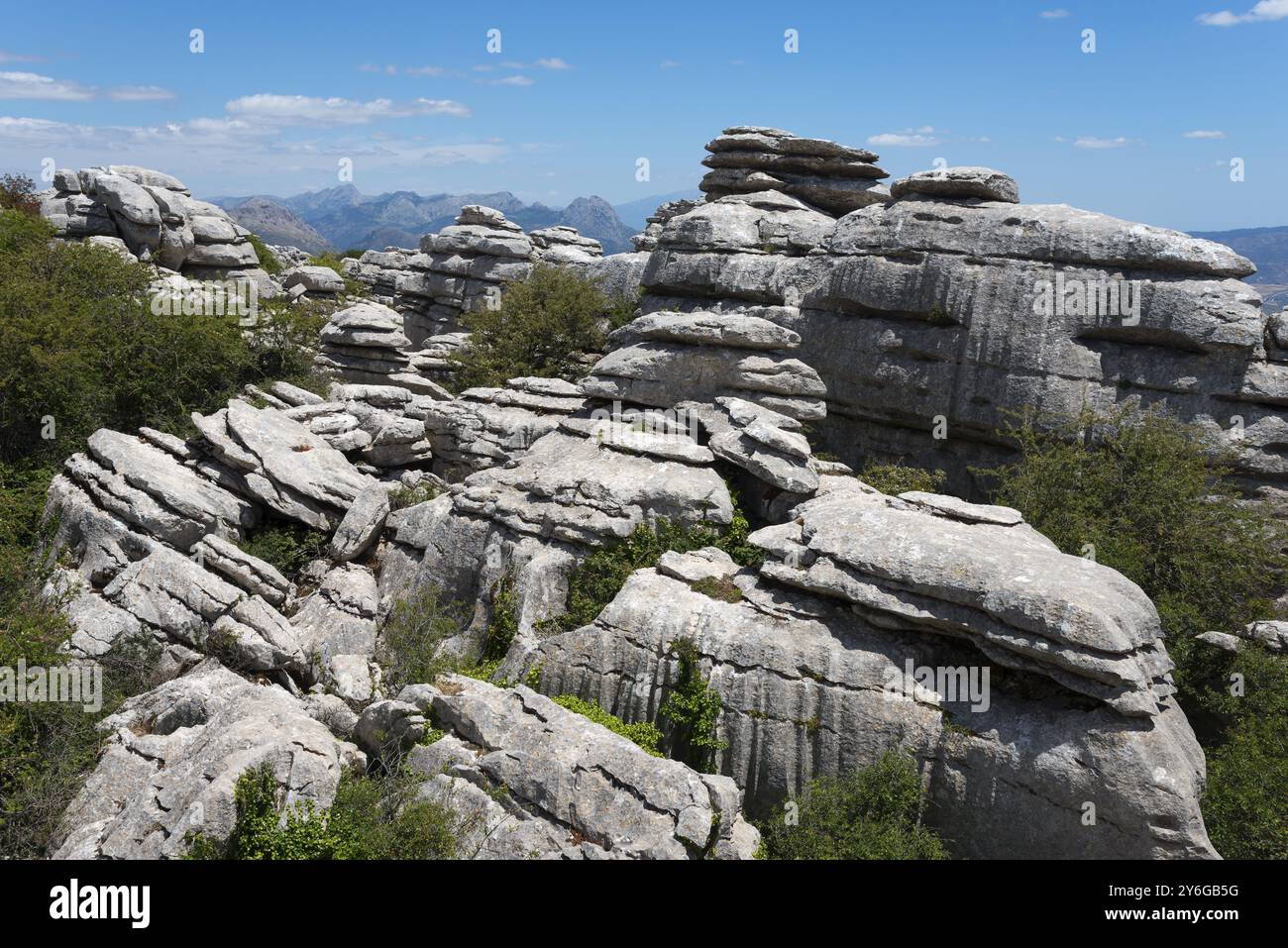 Dry rock formations of different heights under a clear blue sky with ...