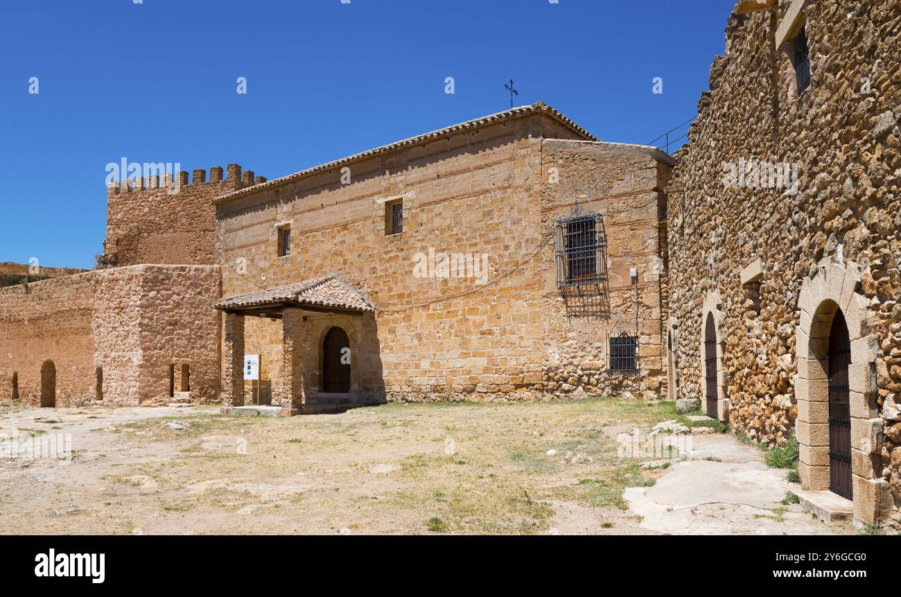 Historic stone structures with fortress wall and church rising under a ...