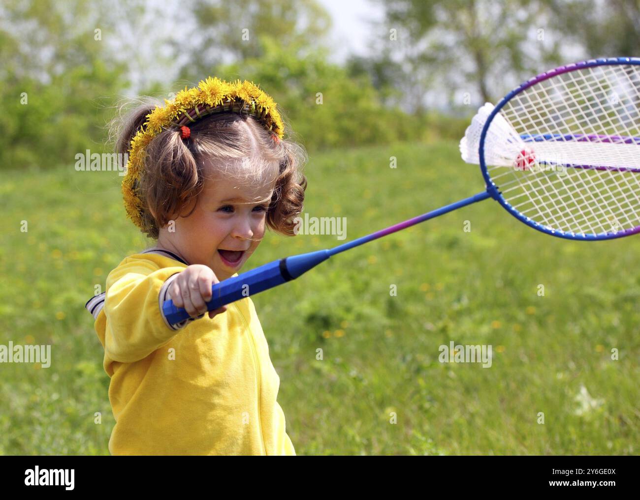 Little girl playing badminton on spring meadow Stock Photo - Alamy