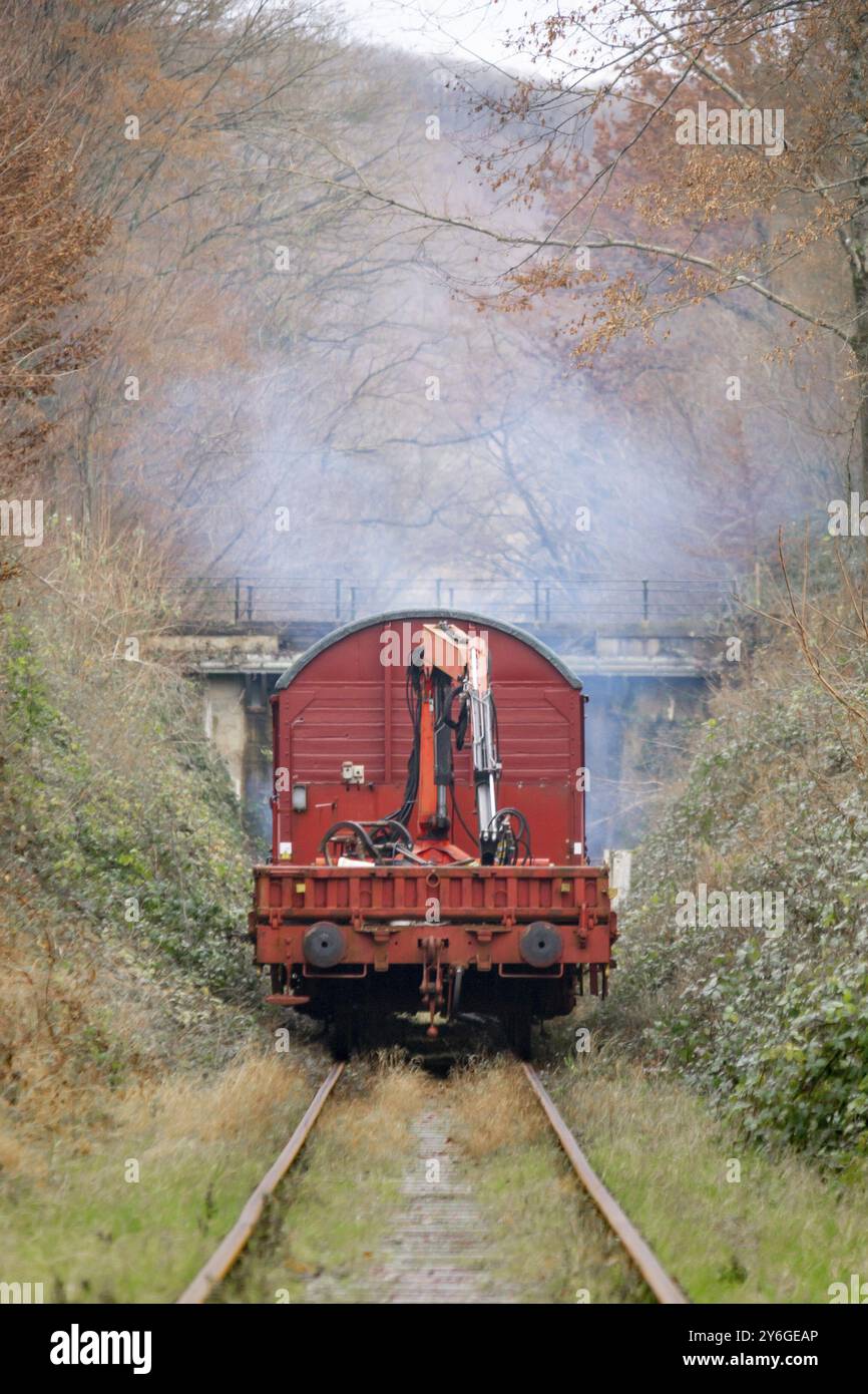 Rear view on maintenance train wagon with crane driving on single train ...