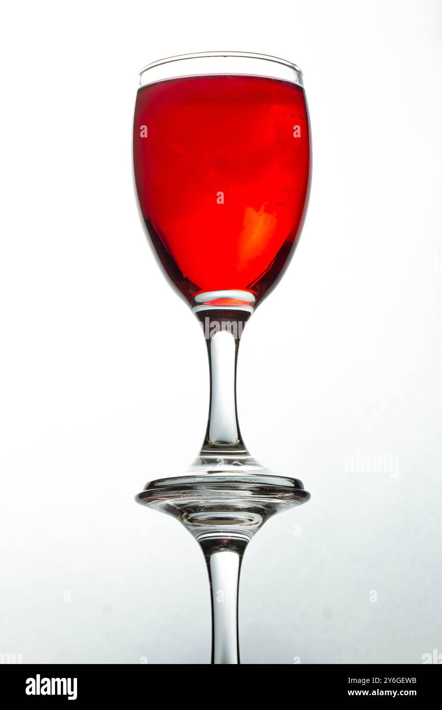 bottom view photo of reflective red liquid glass on white background ...