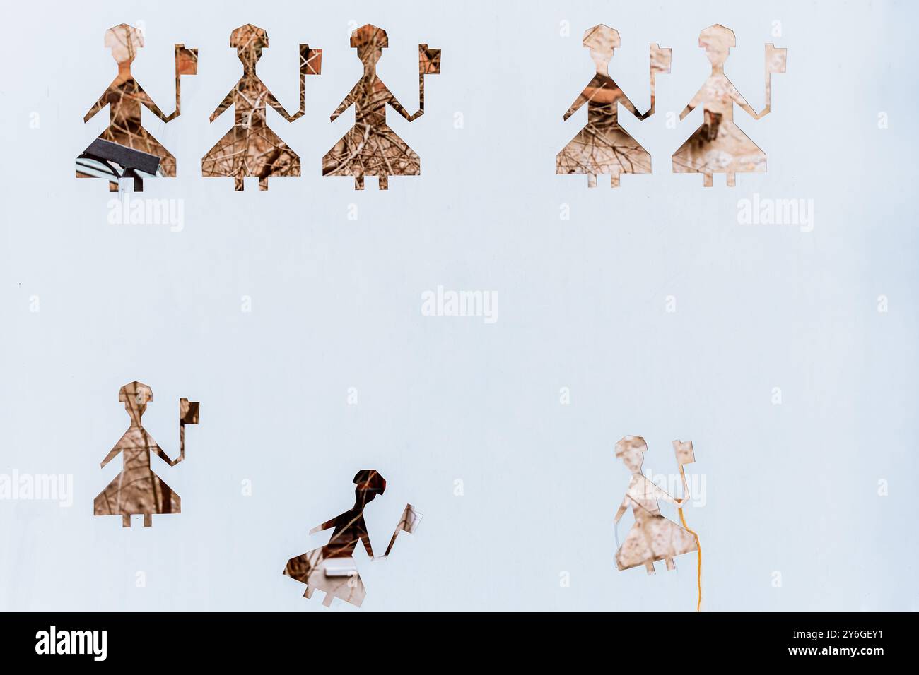 A pattern of women in traditional Greek costumes cut out on wall, Greek ...