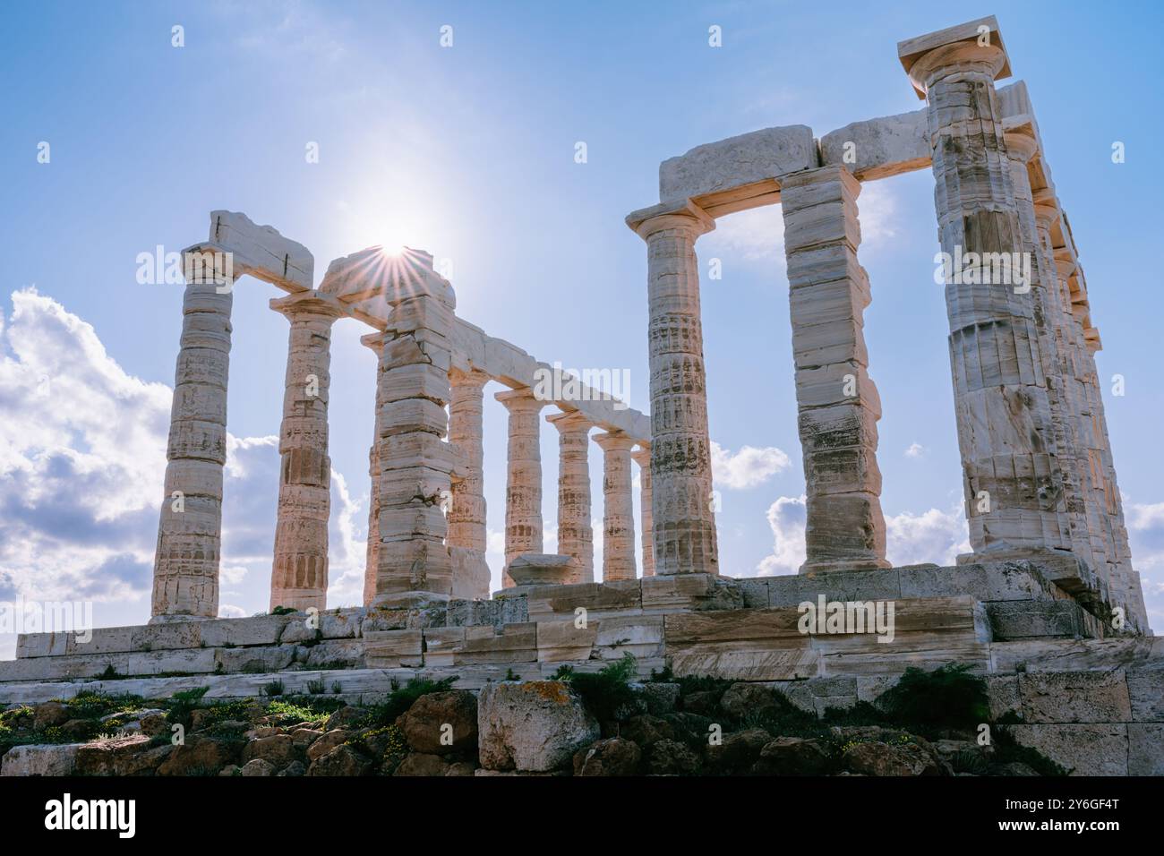 Ancient columns of the Temple of Poseidon rise high under bright sky ...