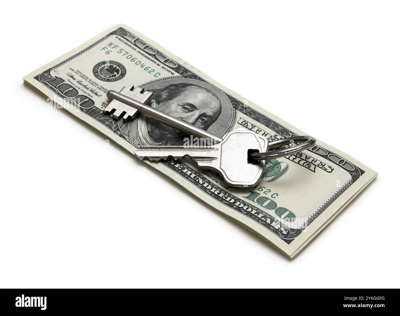 Buying house, keys on stack of hundred-dollar bills Stock Photo - Alamy