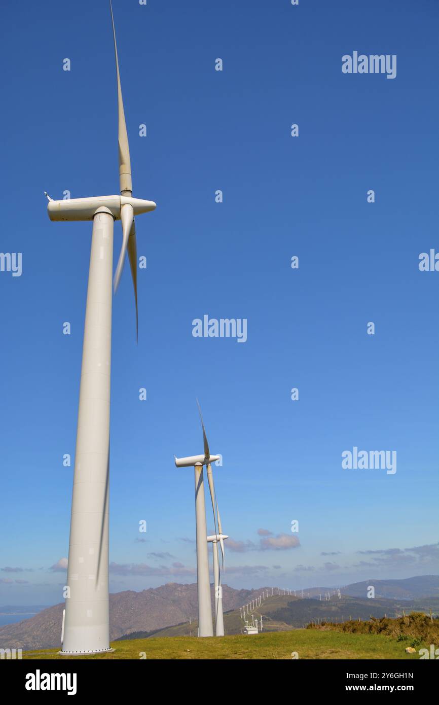 Landscape with lined up wind turbines of a wind farm on a mountain rig ...