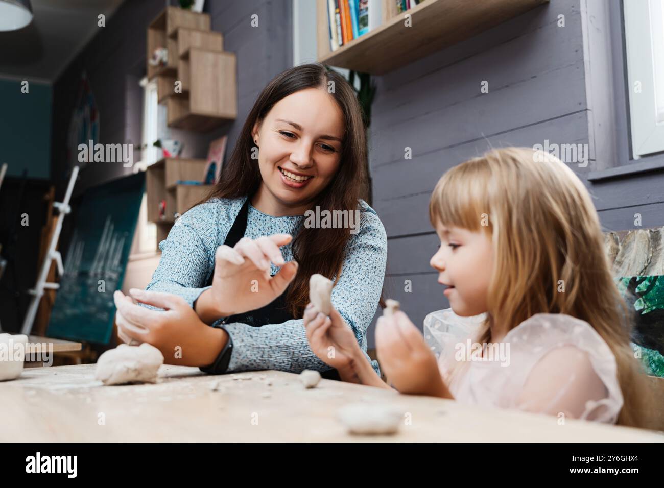 Girl and her mother enjoying a fun clay modeling activity indoors Stock ...