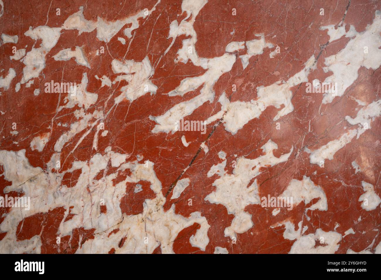Natural red and white marble texture with organic veining, showcasing a ...