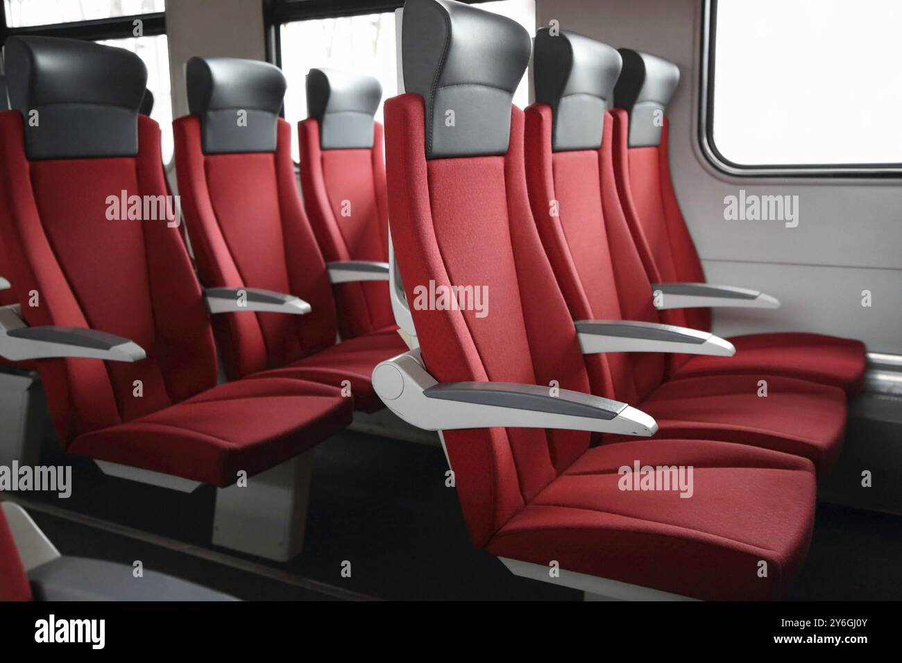 Rows of red seats in modern train Stock Photo - Alamy