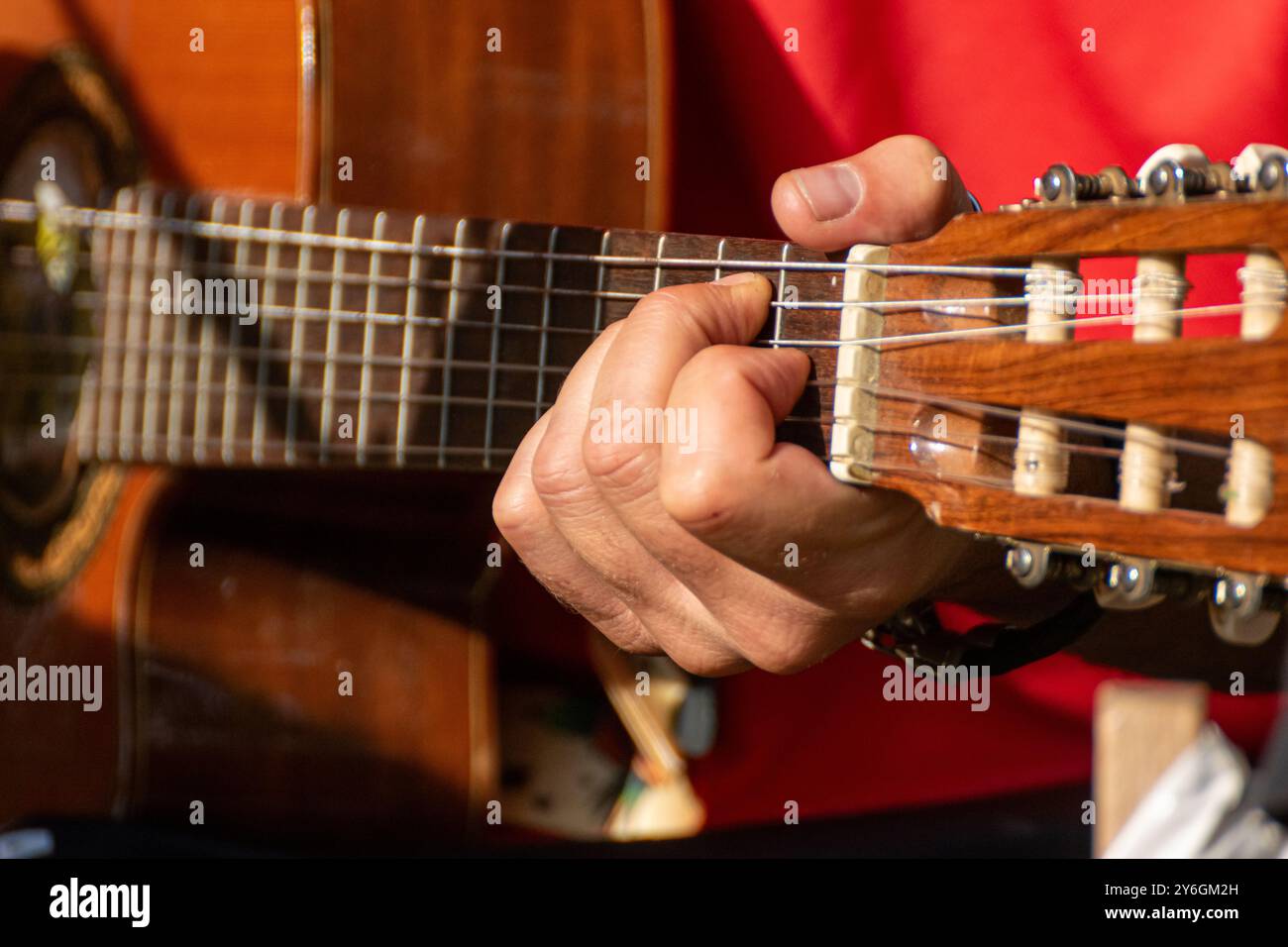fingers of a man's hand playing a Spanish guitar, music concept Stock ...
