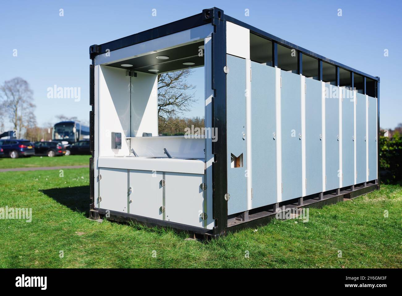 A modern mobile restroom with multiple stalls running water for washing ...