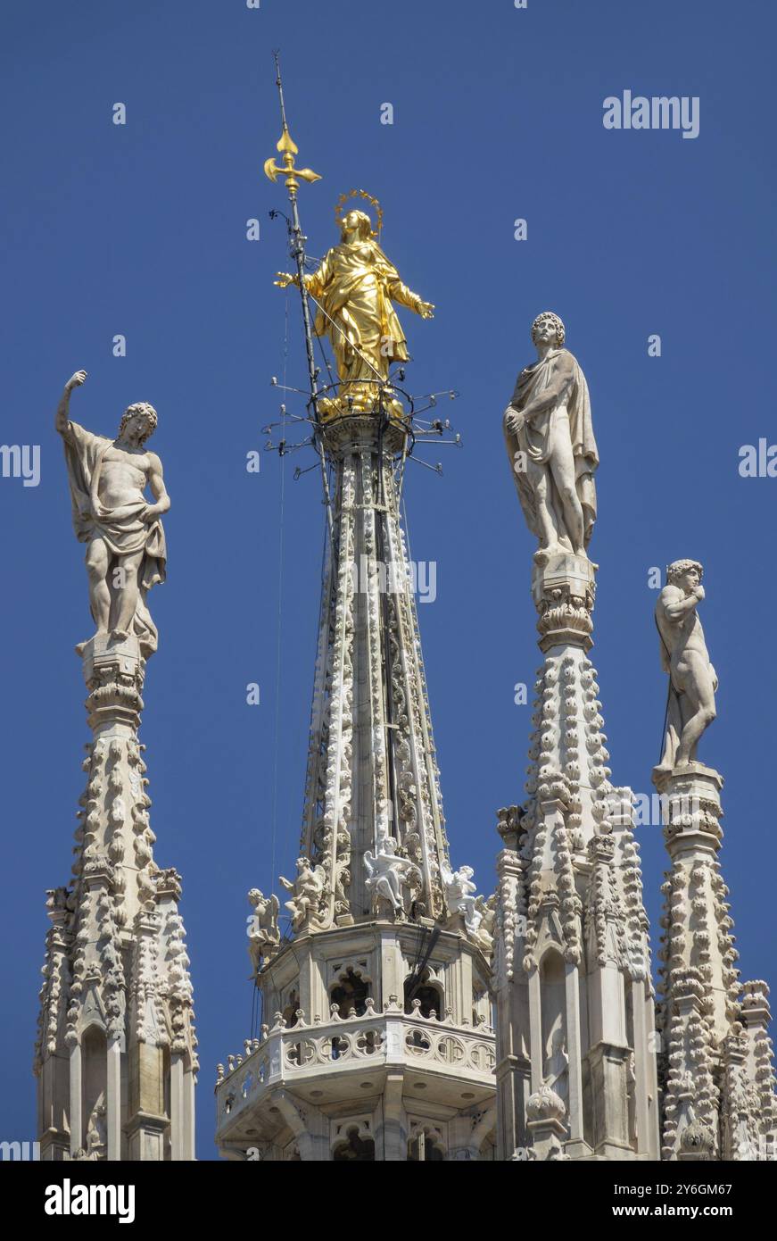 Statues, architecture on top of roof Duomo gothic cathedral in Milan ...