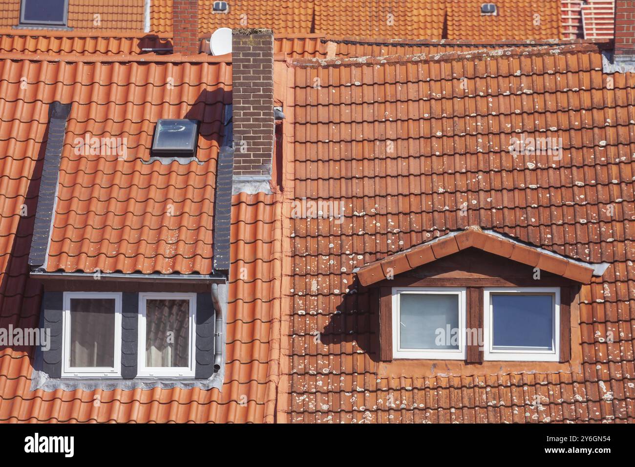 Reddish roof with roof tiles and skylights in the historic city centre ...