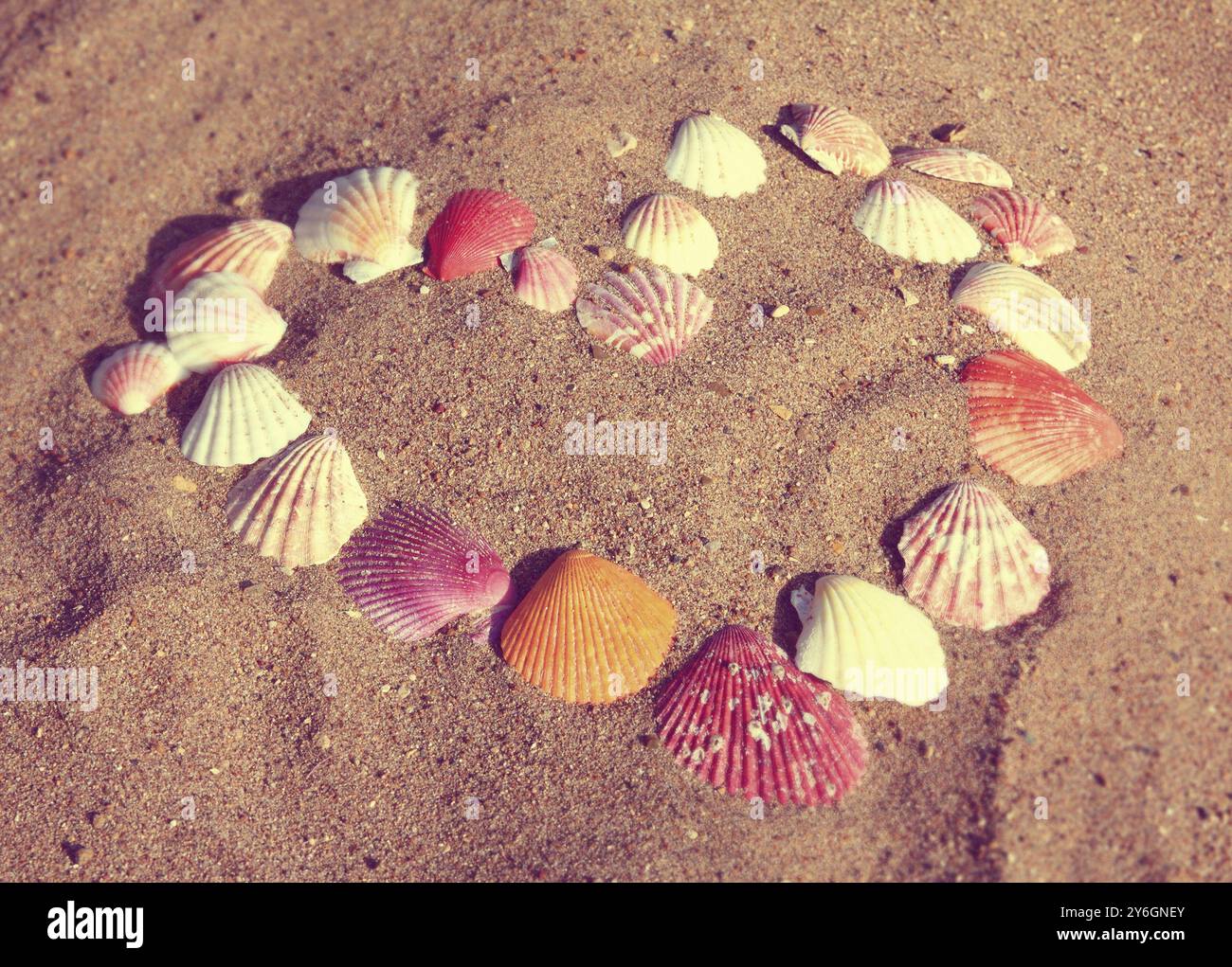 Heart symbol from sea shells on sand, vintage retro style Stock Photo ...