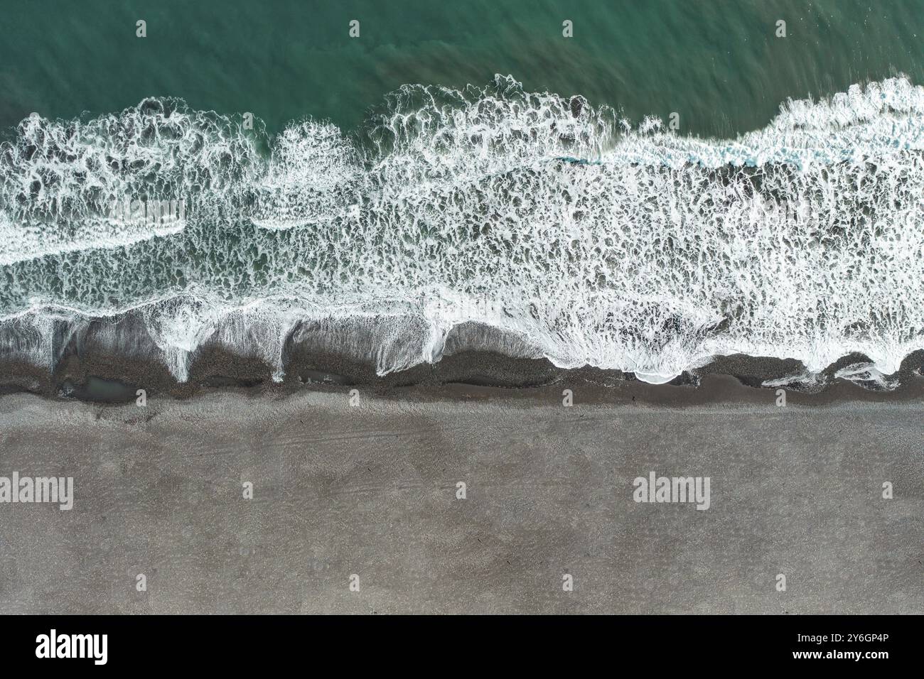 Aerial view of chilean ocean with black snd beach. Top view from drone ...
