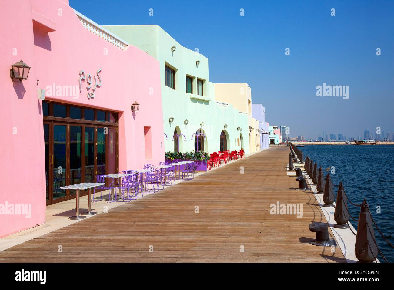Colorful restaurants and cafes along the promenade of the Old Doha Port in Doha, Qatar Stock ...