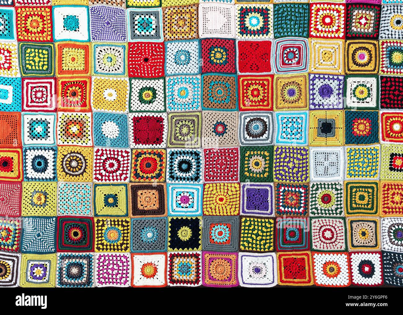 Top view of handmade multi colored plaid make from crochet granny ...