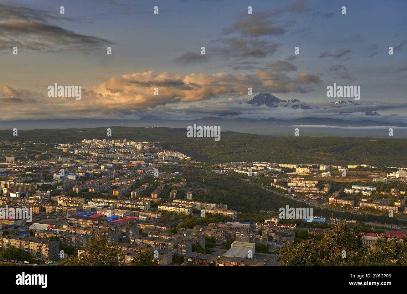 Petropavlovsk-Kamchatsky city at sunset and cone of Koryak volcano ...