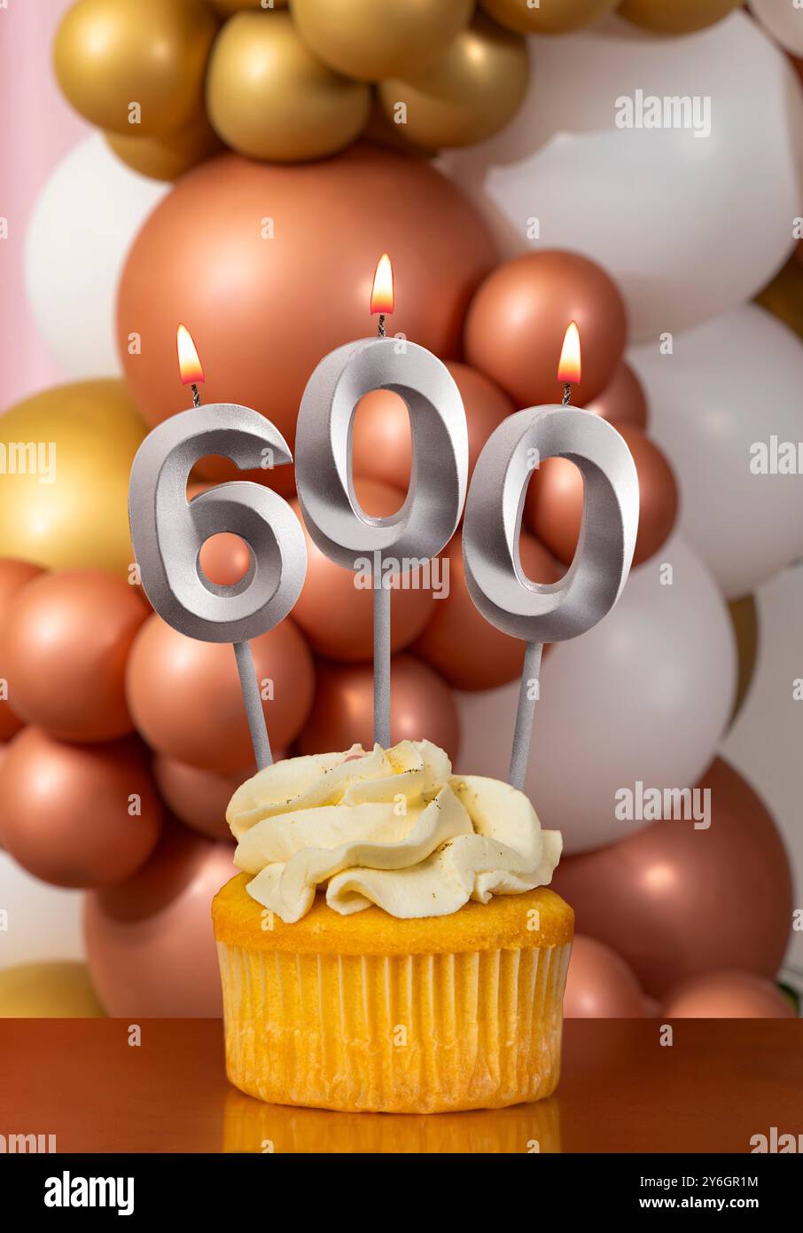 Cupcake with birthday candle on balloons background - Number 600 Stock ...