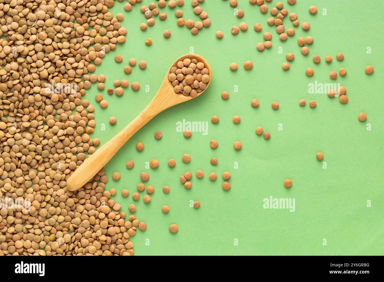 Raw brown lentils on a spoon - Lens culinaris Stock Photo - Alamy