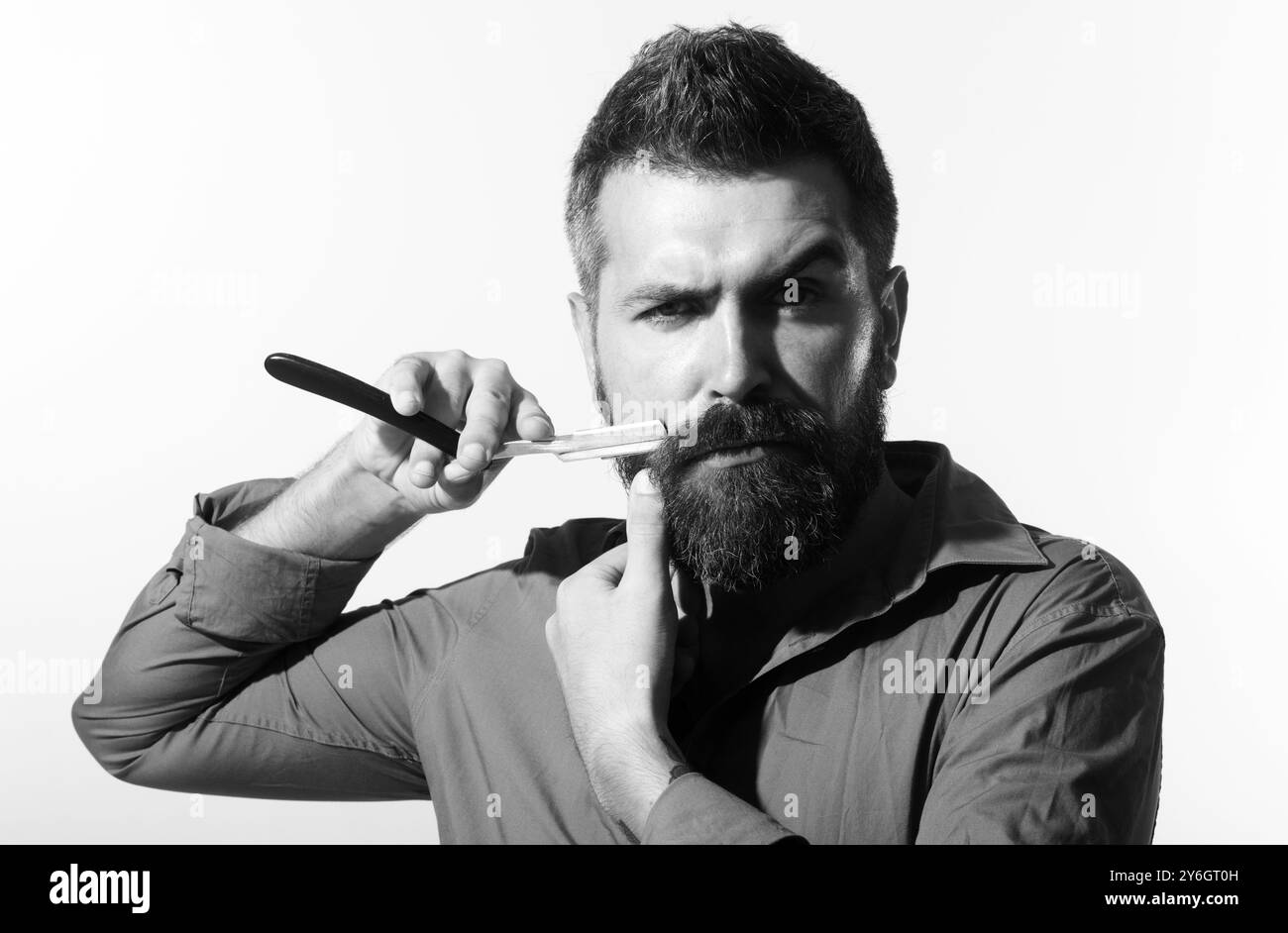 Serious bearded man with straight razor. Barbershop, shaving, haircut ... Serious bearded man with straight razor. Barbershop, shaving, haircut ...