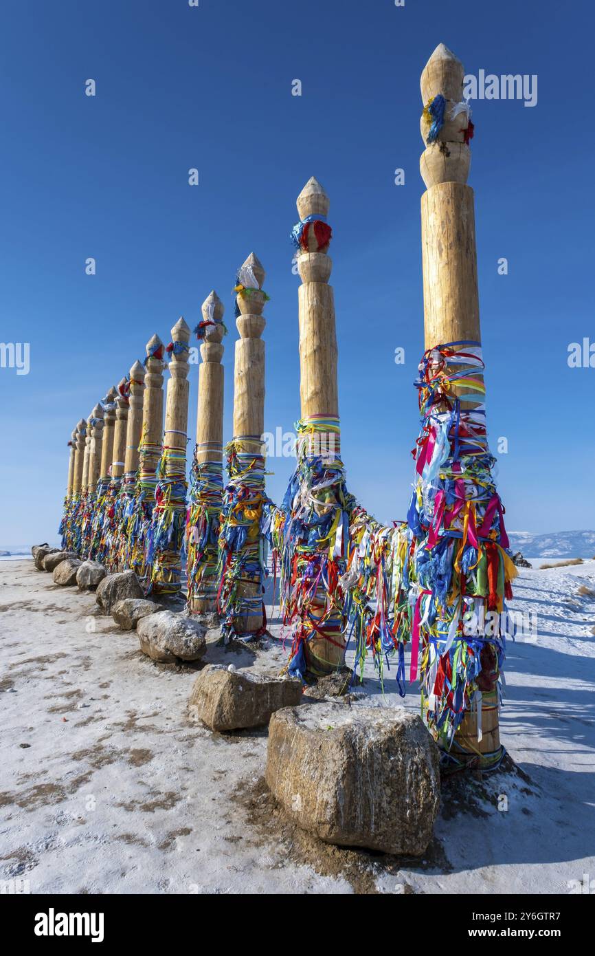 Wooden ritual pillars with colorful ribbons on cape Burkhan, Lake ...